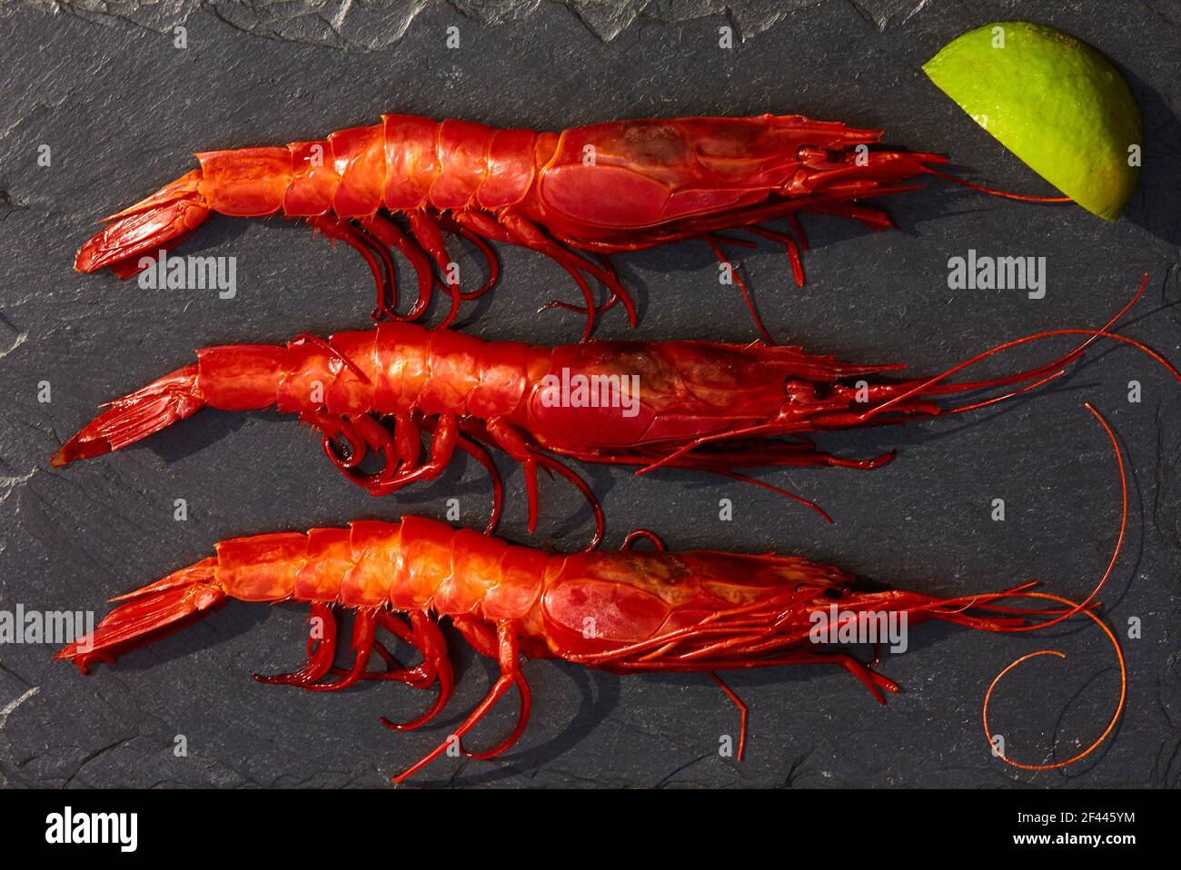 Fresh big red shrimp on a black stone table top view Stock Photo - Alamy