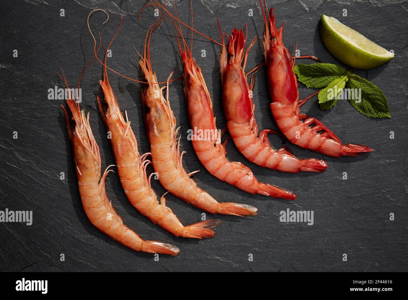Fresh big red shrimp on a black stone table top view Stock Photo - Alamy