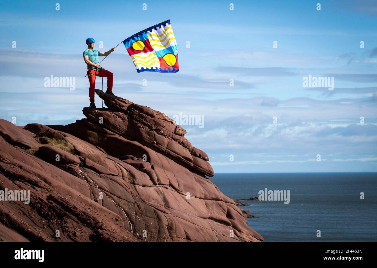 Outdoor adventurer Kevin Meldrum flies one of the flags created for the ...