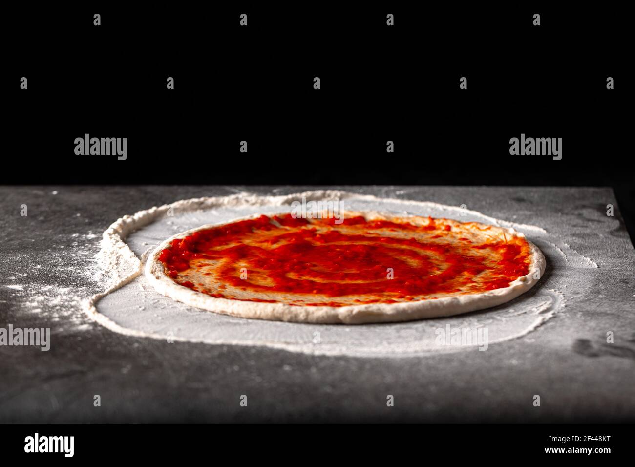Prepared dough base for pizza with tomato sauce Stock Photo - Alamy