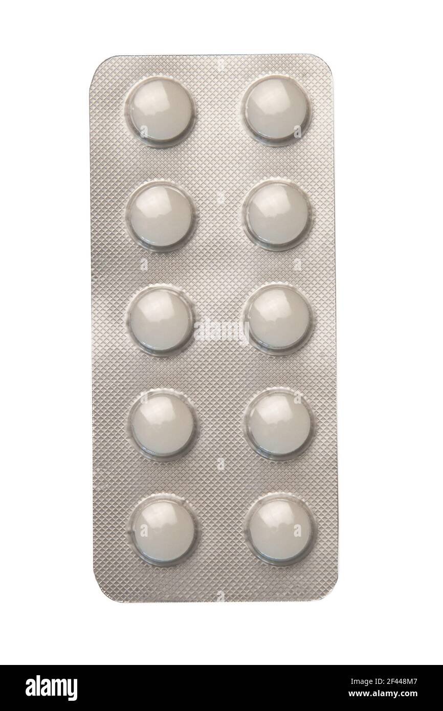 Round tablets in a silver blister pack isolated on a white background ...