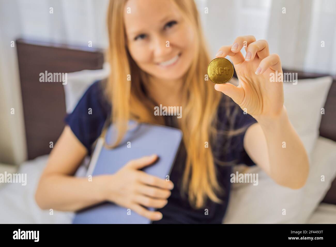 NFT Young woman, a digital artist, creates digital art on a tablet at ...