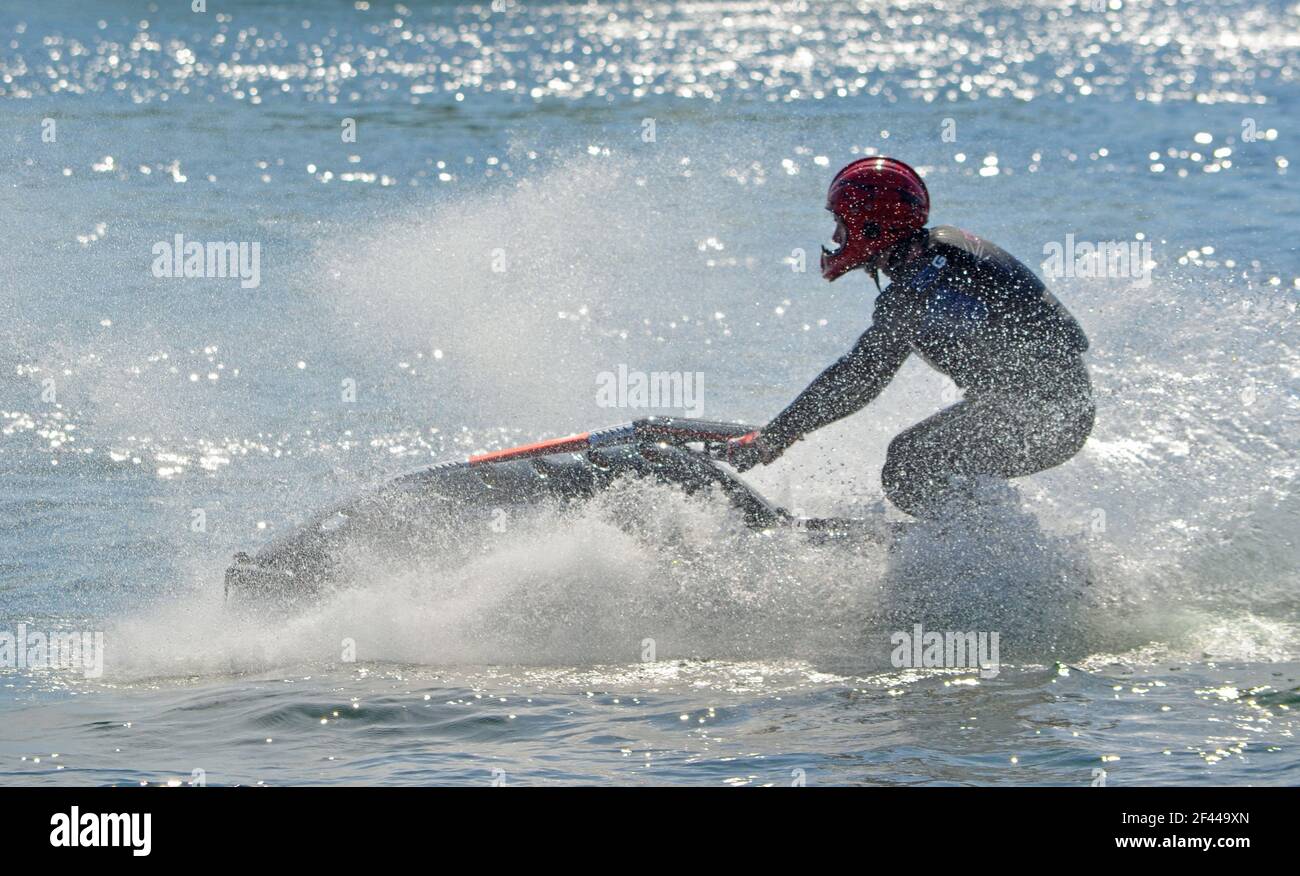 Freestyle Jet Skier making a lot of spray backlit Stock Photo - Alamy