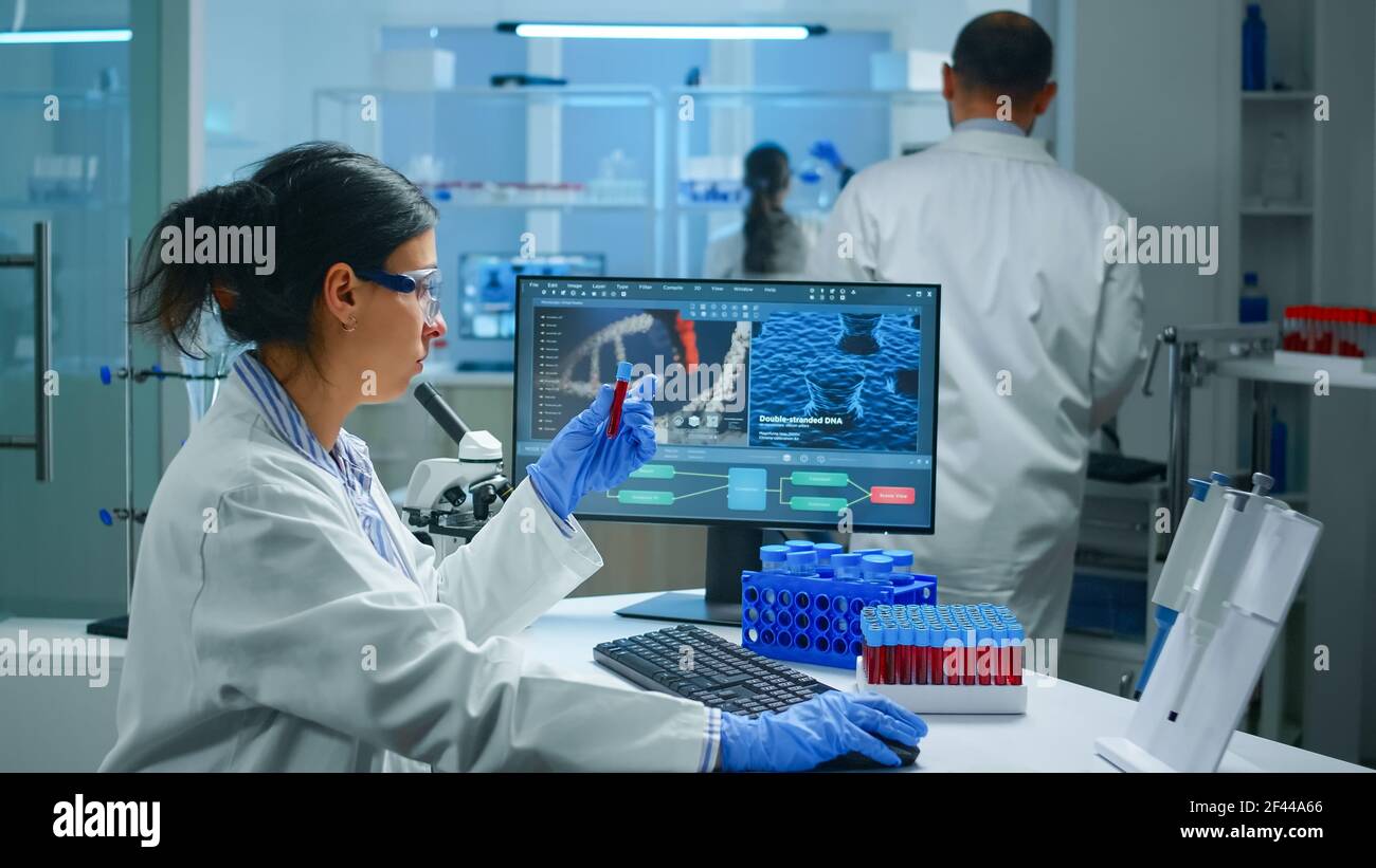 Group of scientists wearing lab coat working in laboratory while ...