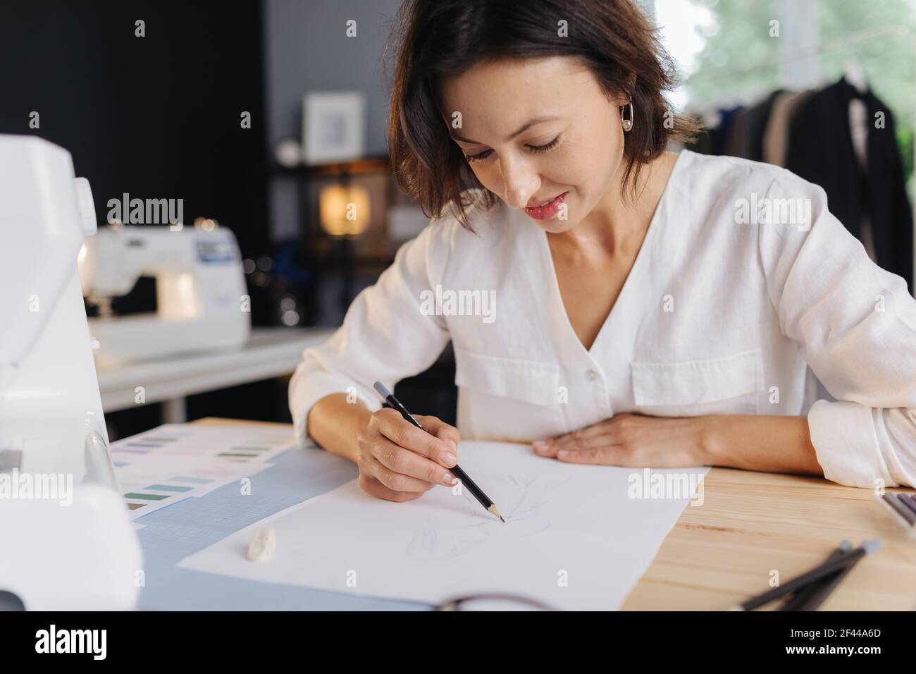 Designer drawing a sketches for new collection Stock Photo - Alamy
