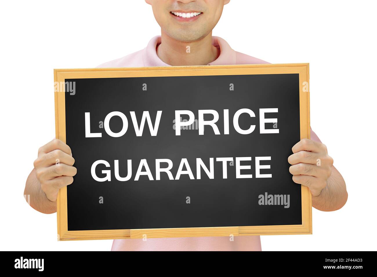 LOW PRICE GUARANTEE text on blackboard held by smiling man Stock Photo ...