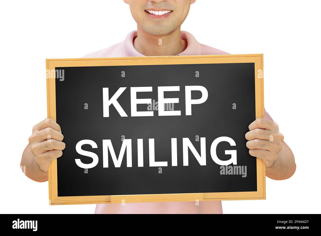 KEEP SMILING words on blackboard held by smiling man Stock Photo - Alamy