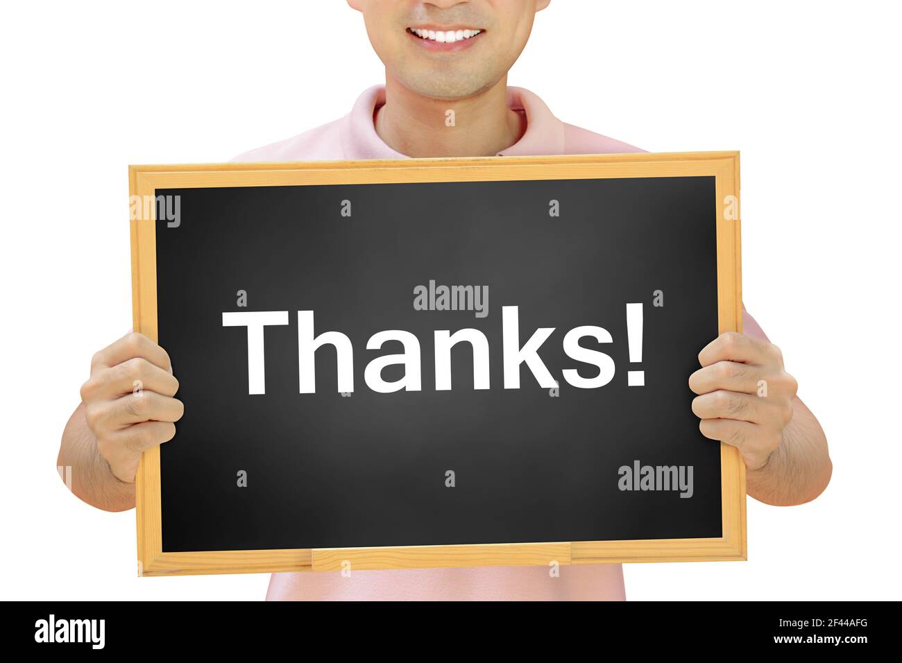Thanks word on blackboard held by smiling man Stock Photo - Alamy