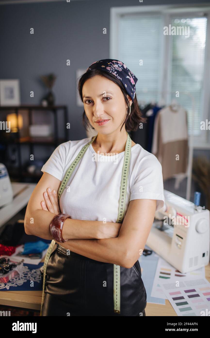 Female a dressmaker posing at a workshop Stock Photo - Alamy