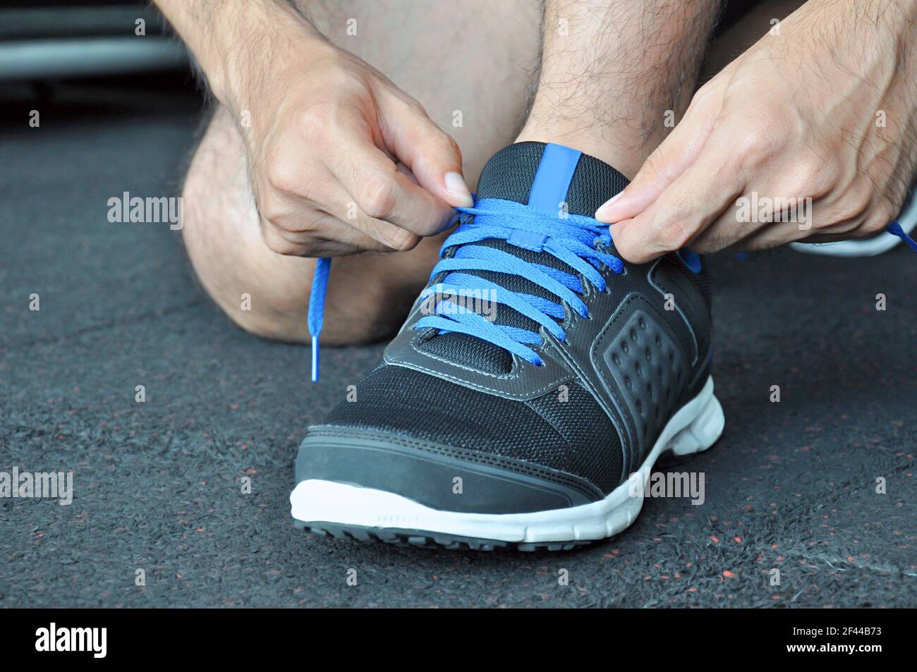Hands tying sports shoe Stock Photo - Alamy