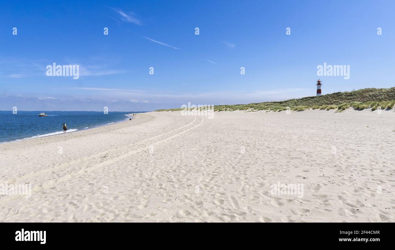 A lighthouse at a white sand beach Stock Photo - Alamy