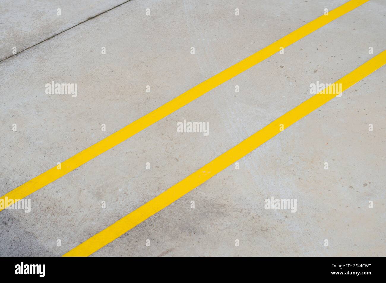 A high angle shot of yellow painted lines on the ground in the street ...