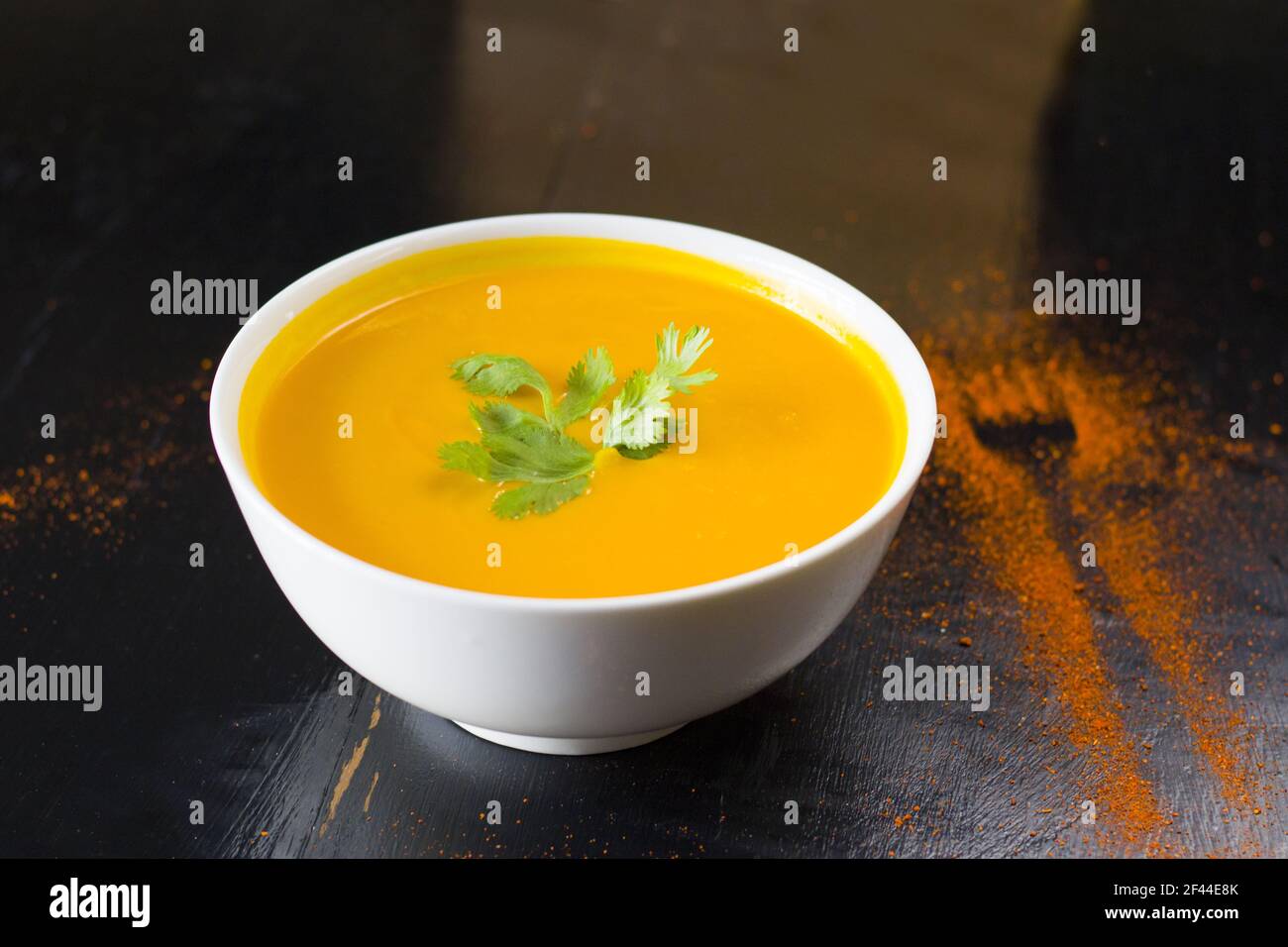 A closeup shot of an appetizing yellow pumpkin cream soup in the bowl ...