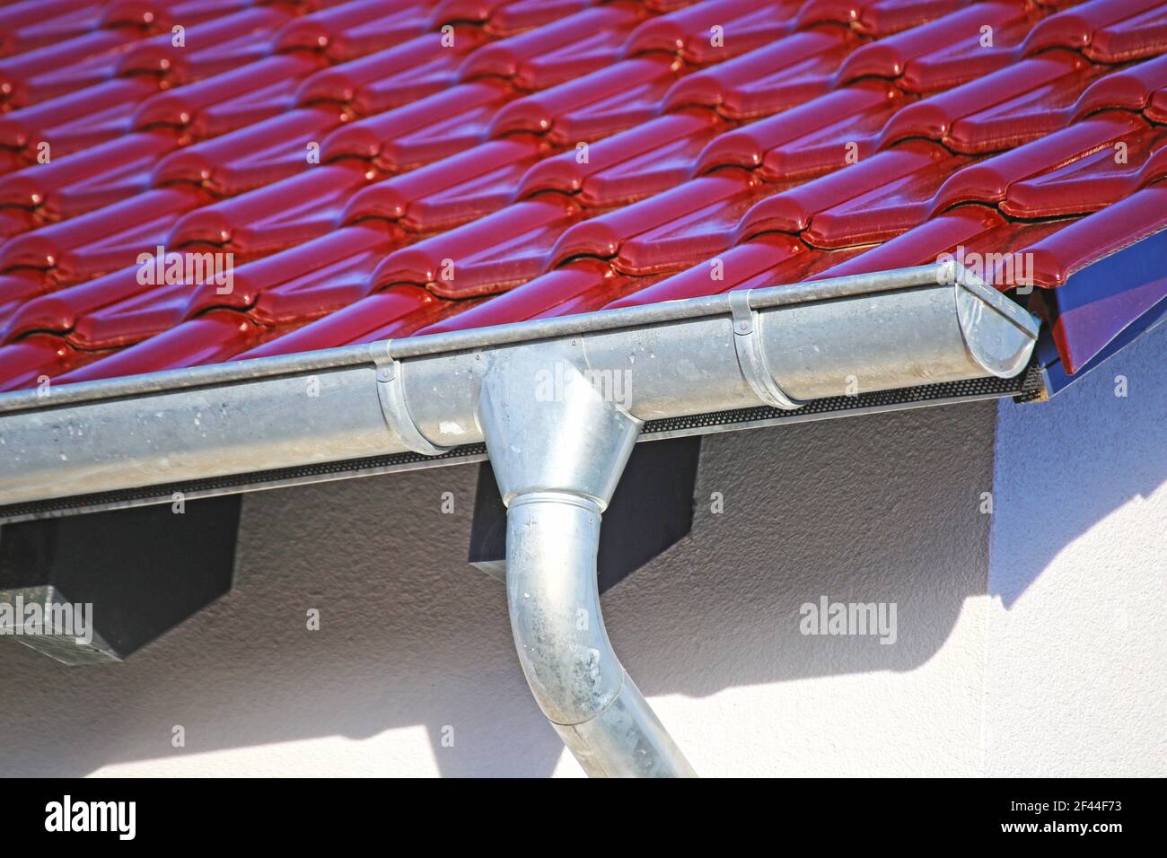 Roof gutter on a new tiled roof Stock Photo - Alamy