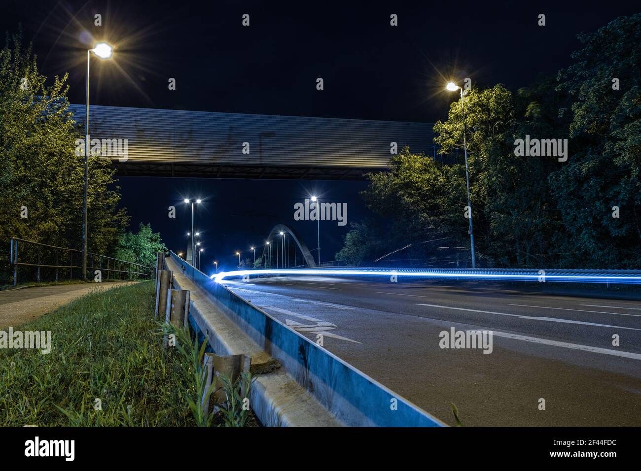 A highway illuminated with light traces at night Stock Photo - Alamy