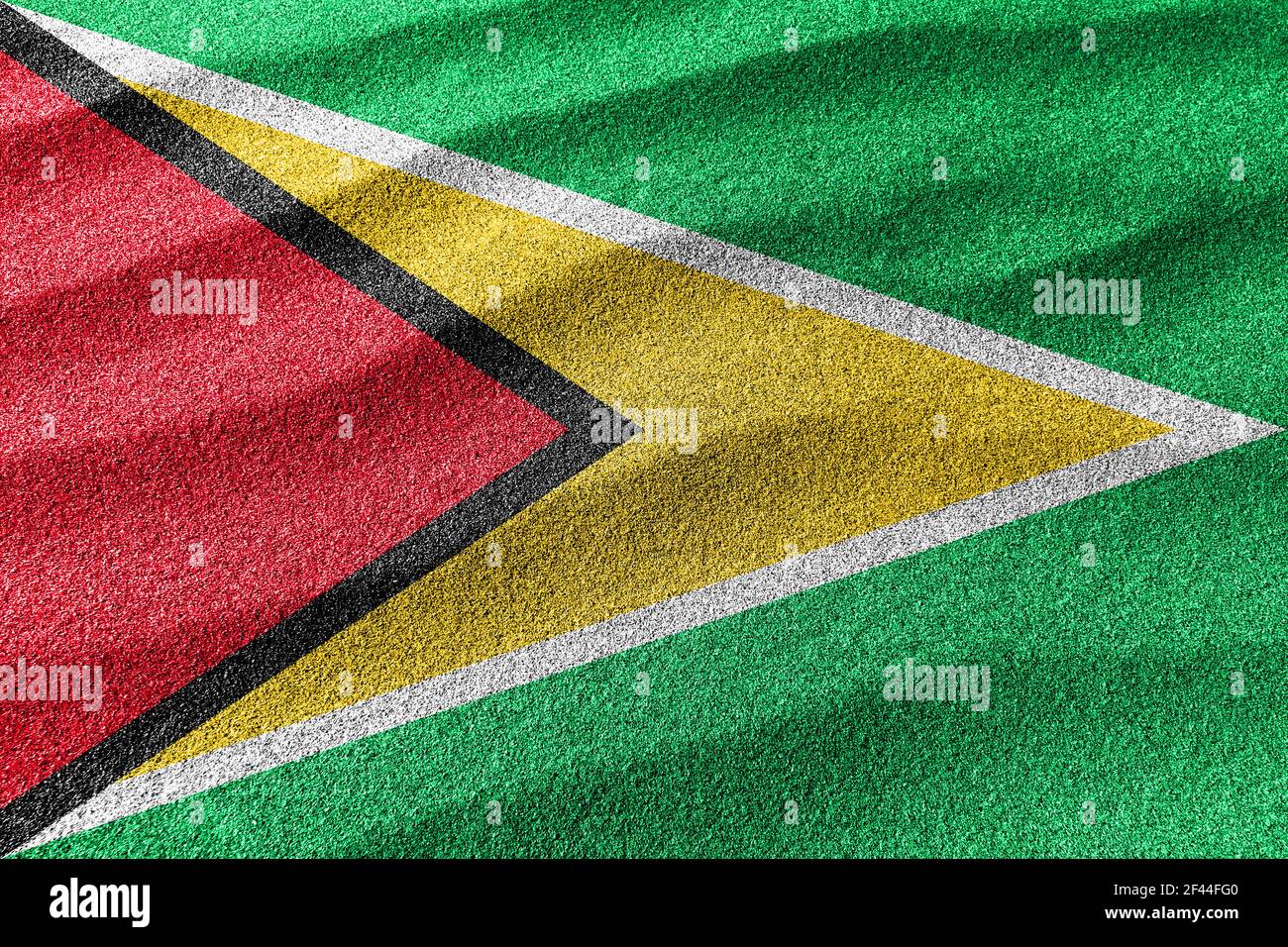 Guyana sand flag, national flag sand background Stock Photo - Alamy