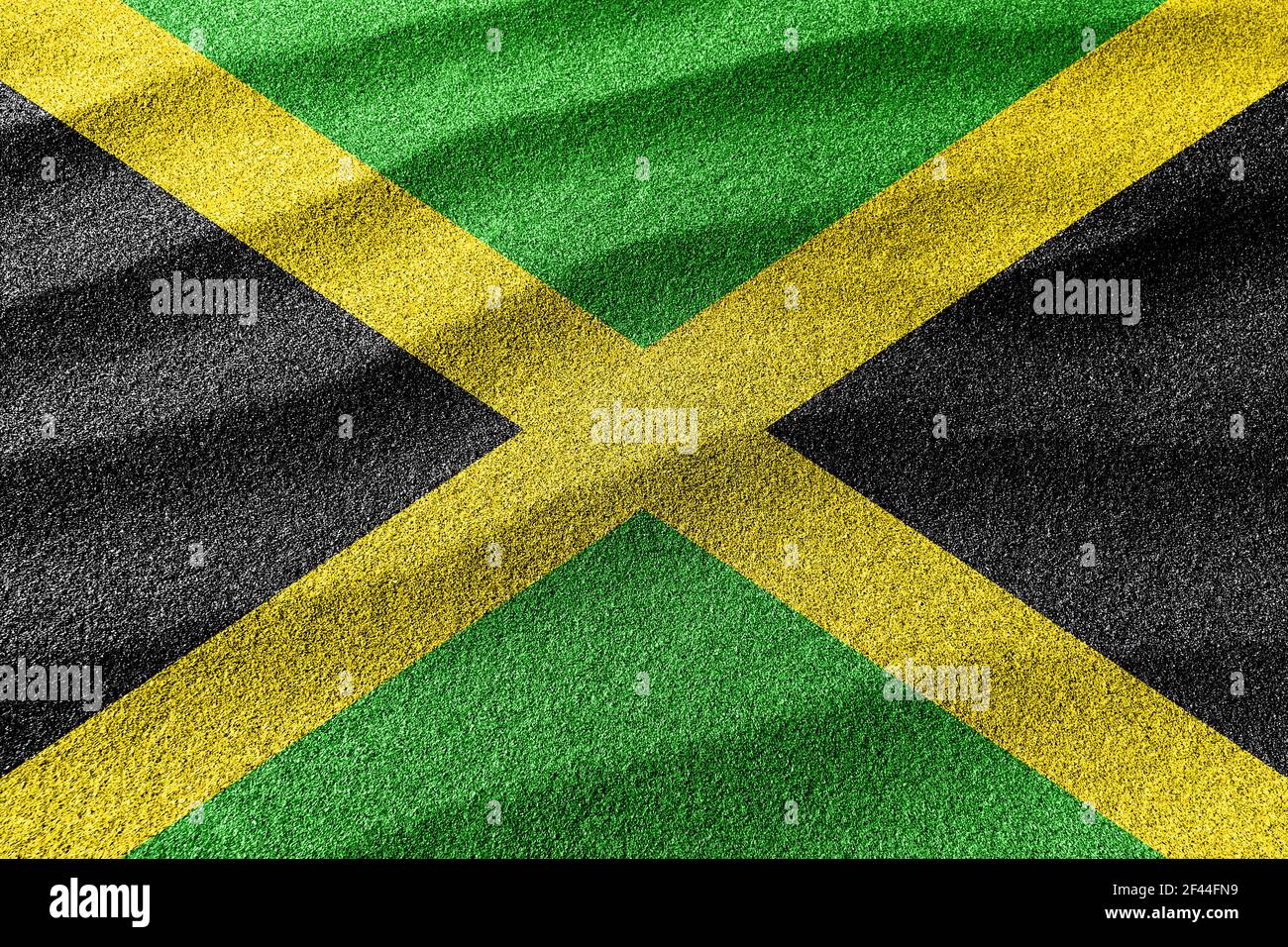 Jamaica sand flag, national flag sand background Stock Photo - Alamy