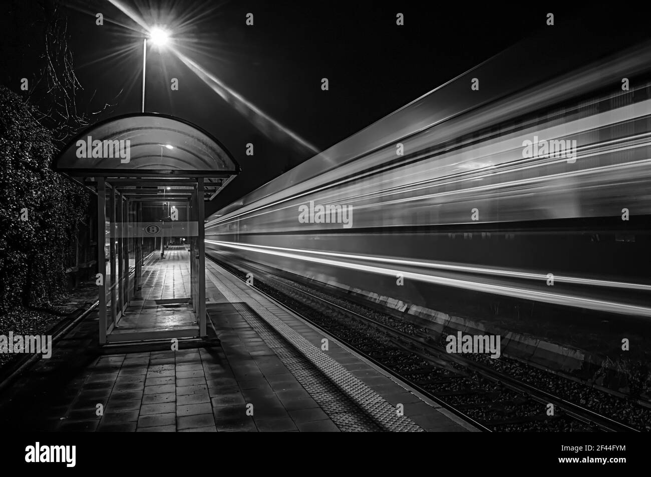 A long exposure shot of a train at an empty station at night Stock ...