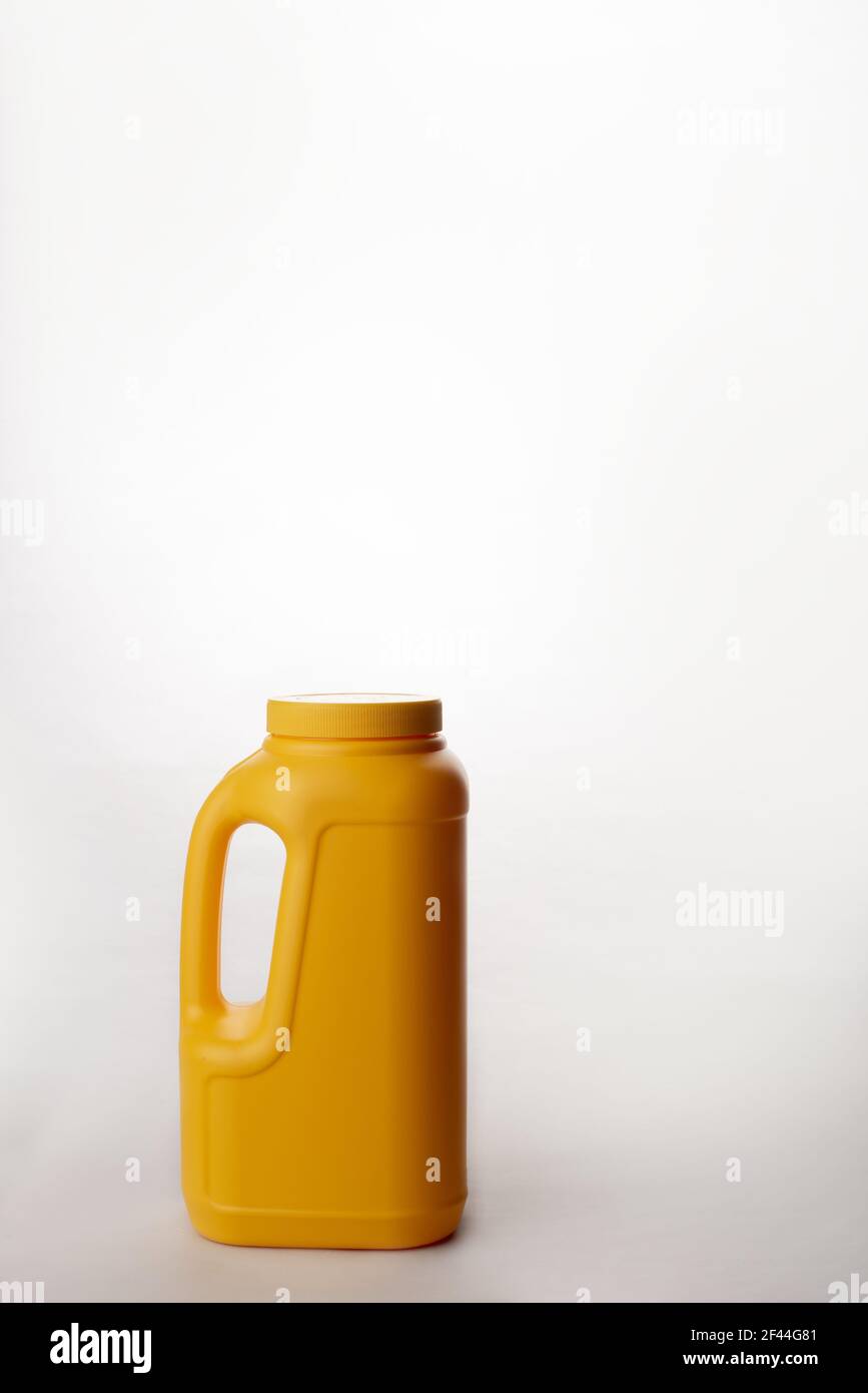 A yellow plastic can isolated on white background Stock Photo - Alamy
