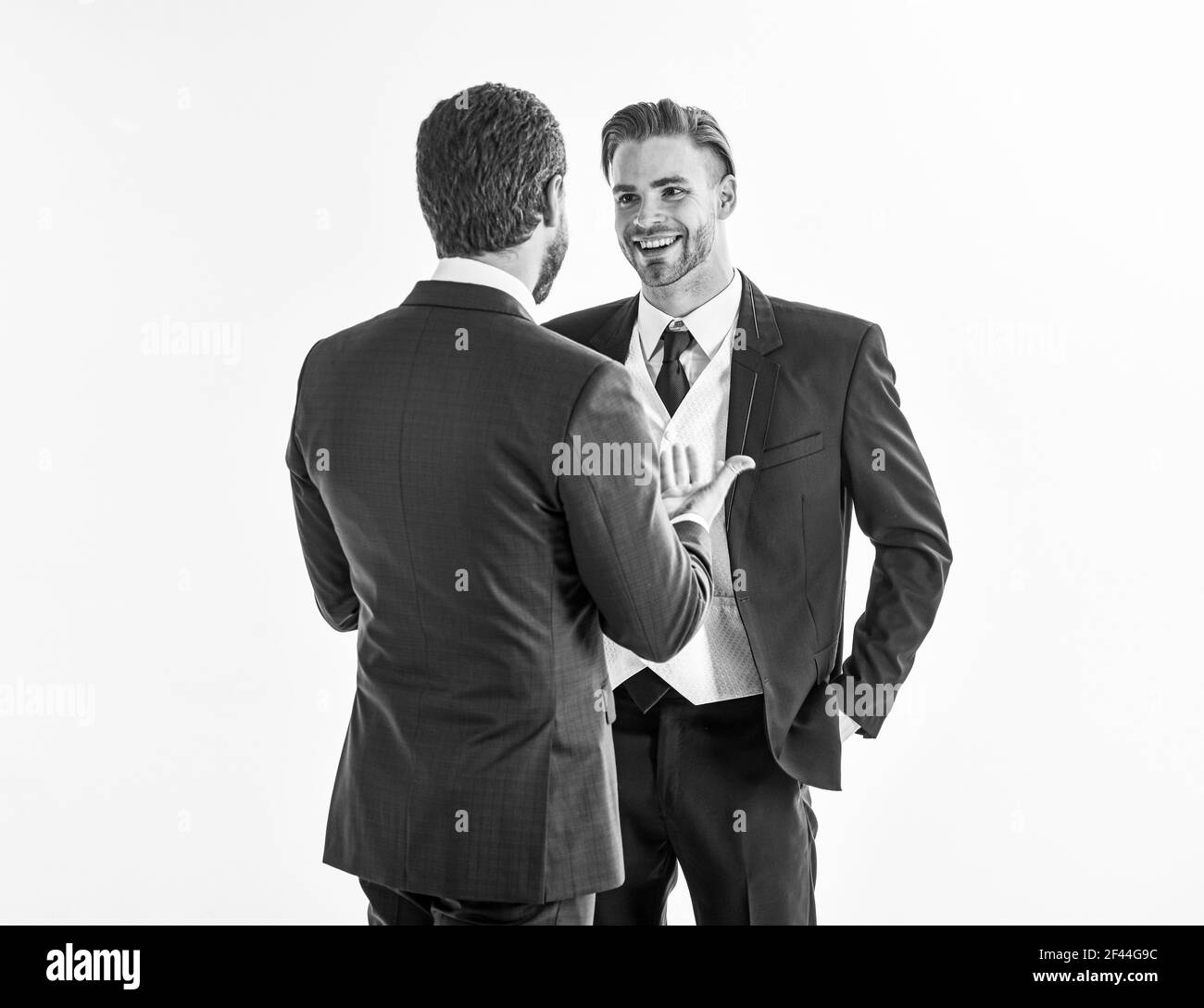 happy men in jacket discussing business , partnership and friendship ...