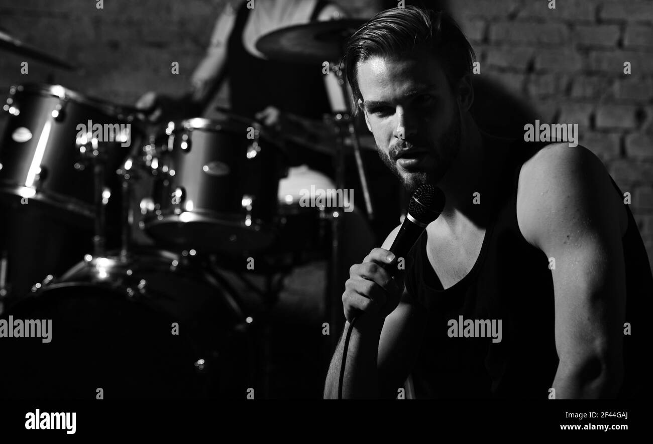 Singer or star sitting on scene and sings. Rock concept Stock Photo - Alamy