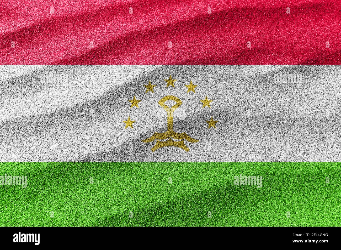 Tajikistan sand flag, national flag sand background Stock Photo - Alamy
