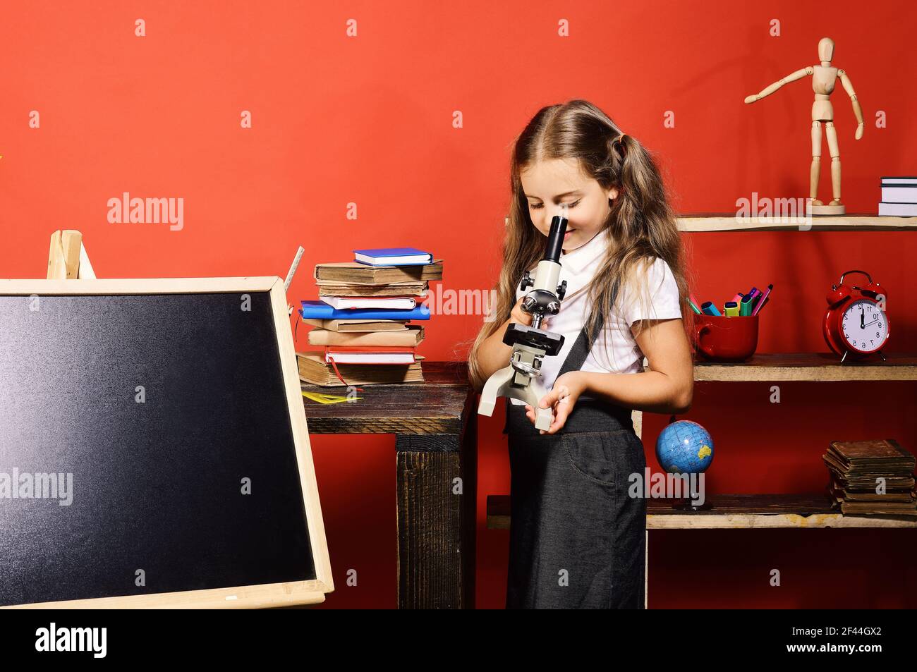 Schoolgirl with smiling face in her classroom. Back to school Stock ...