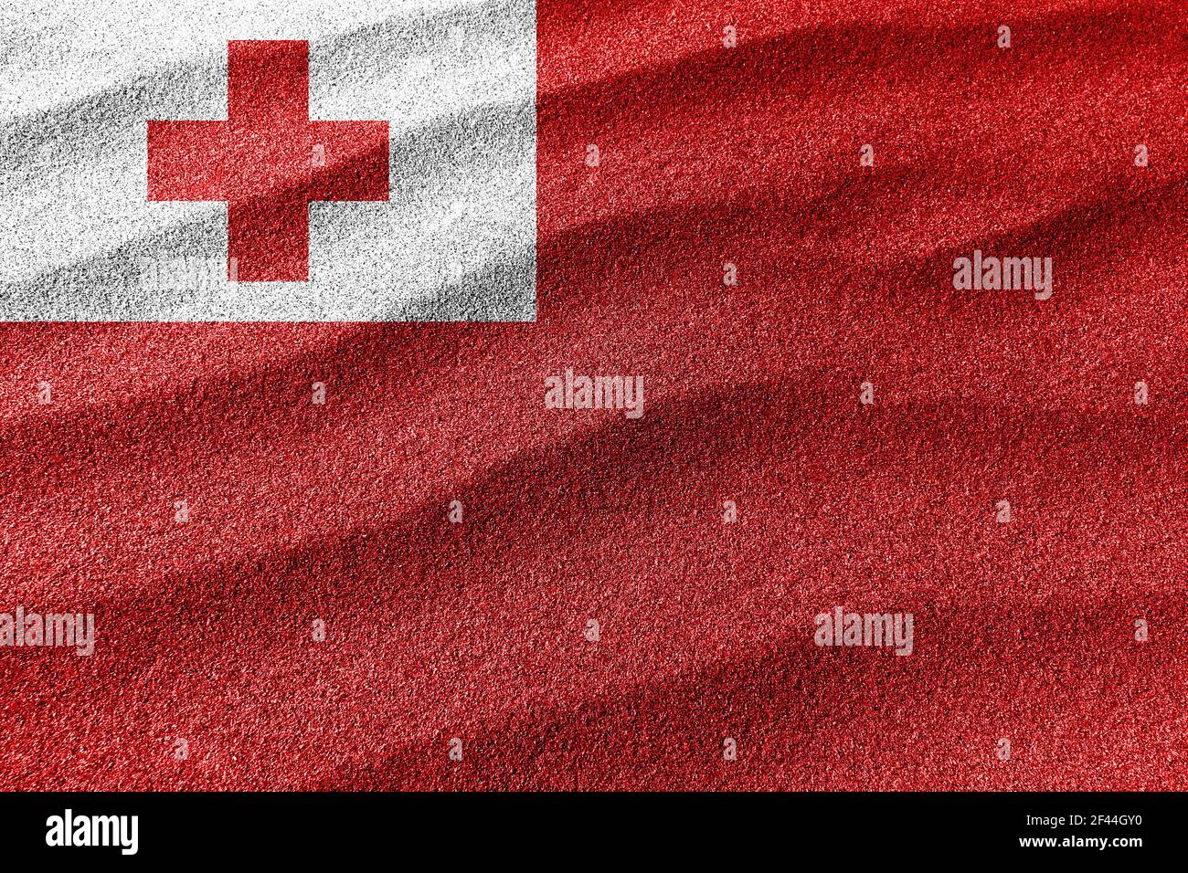 Tonga sand flag, national flag sand background Stock Photo - Alamy