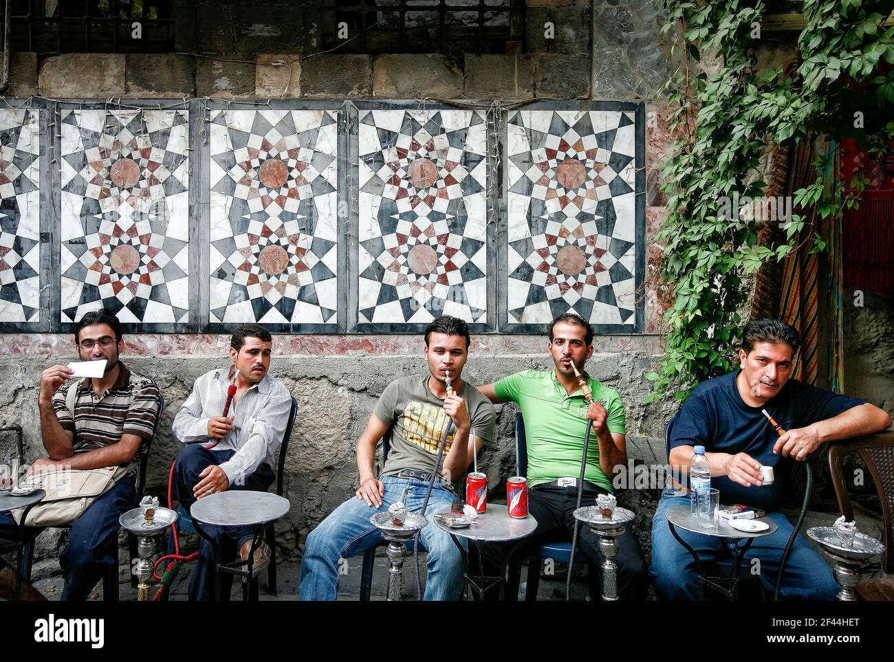 Damascus,Syria - August 03,2010 : People smoking shisha in a cafe in ...
