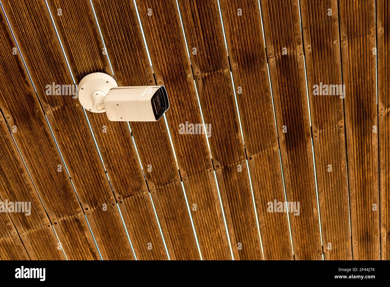 A low angle of a security camera installed on a wooden ceiling Stock ...