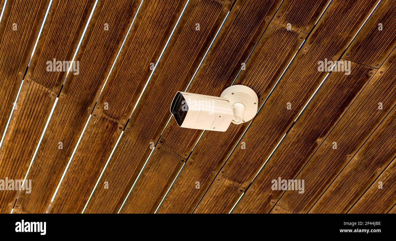 A low angle of a security camera installed on a wooden ceiling Stock ...