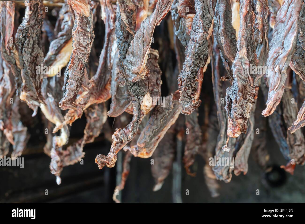 Hanging beef jerky close-up. Dried beef strips. Ready-to-eat treats ...