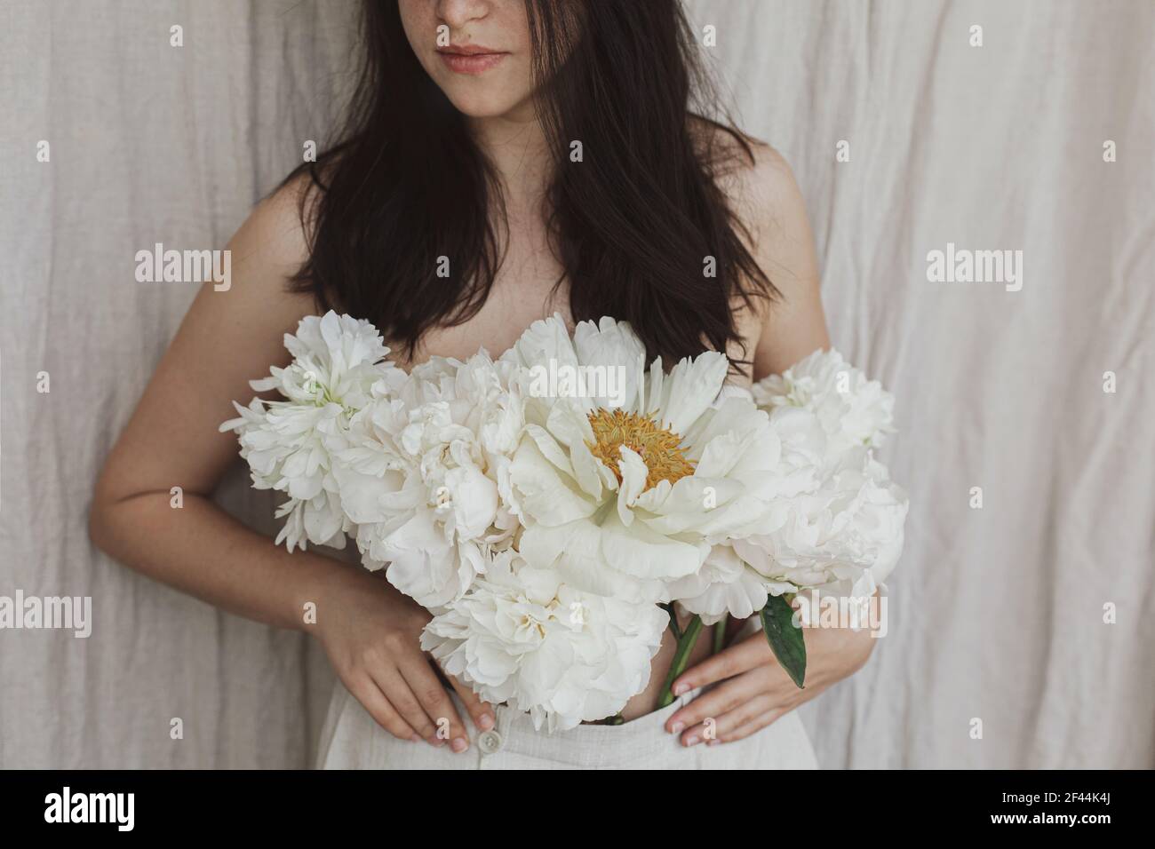 Stylish sensual woman with white peony flowers on body. Beautiful young ...