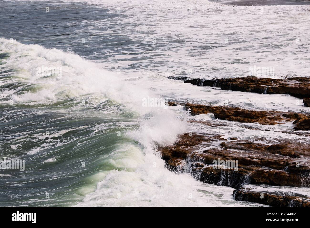 big waves crashing against rocky shoreline in Tasmania, Australia on a ...