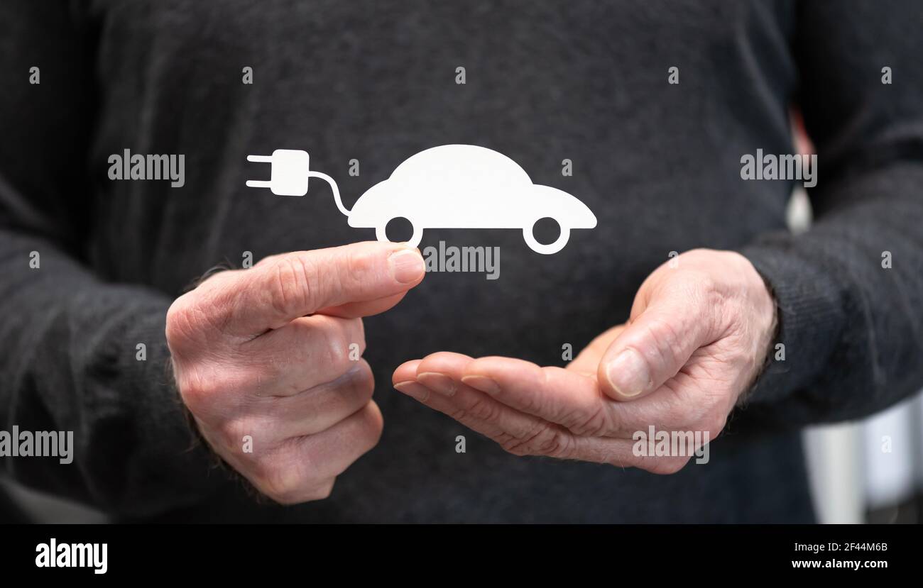 Man holding a paper electric car; Concept of eco friendly car Stock ...