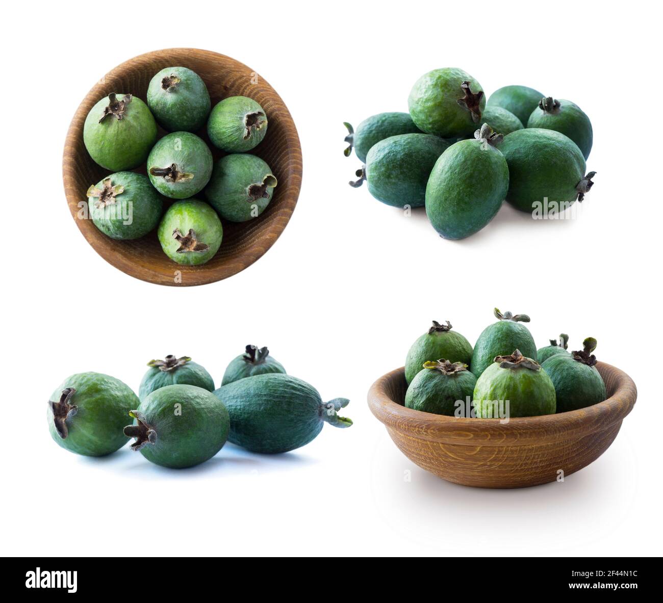Green feijoa fruits in a wooden bowl isolated on white background. Top ...