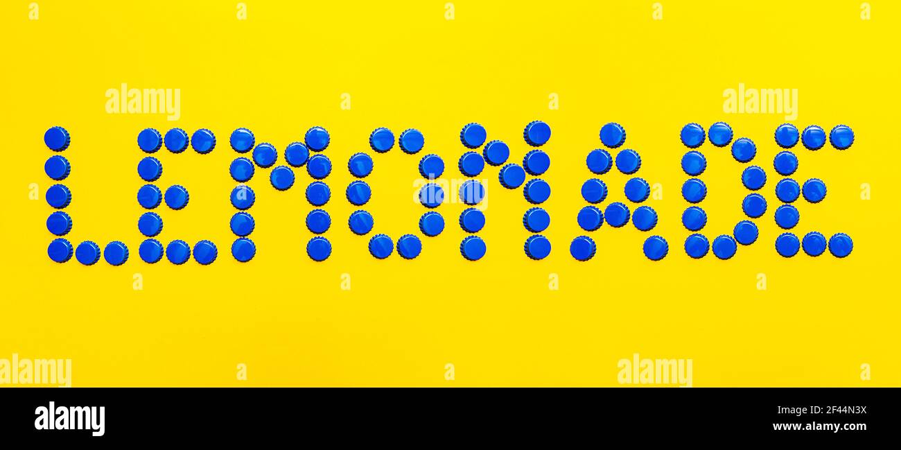 The word LEMONADE is made from blue bottle caps on a yellow background ...
