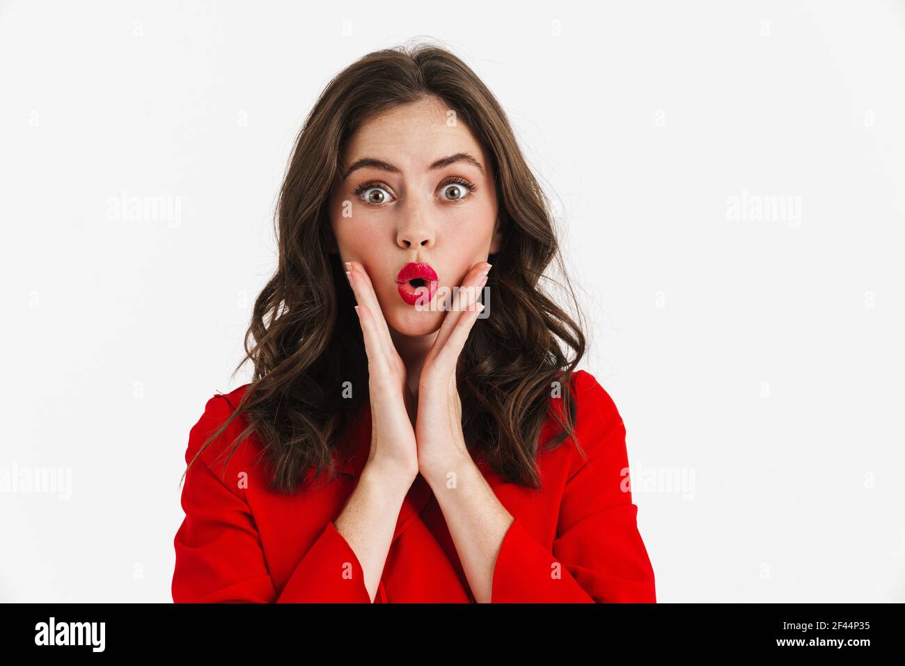 Shocked nice girl wearing red dress expressing surprise on camera ...