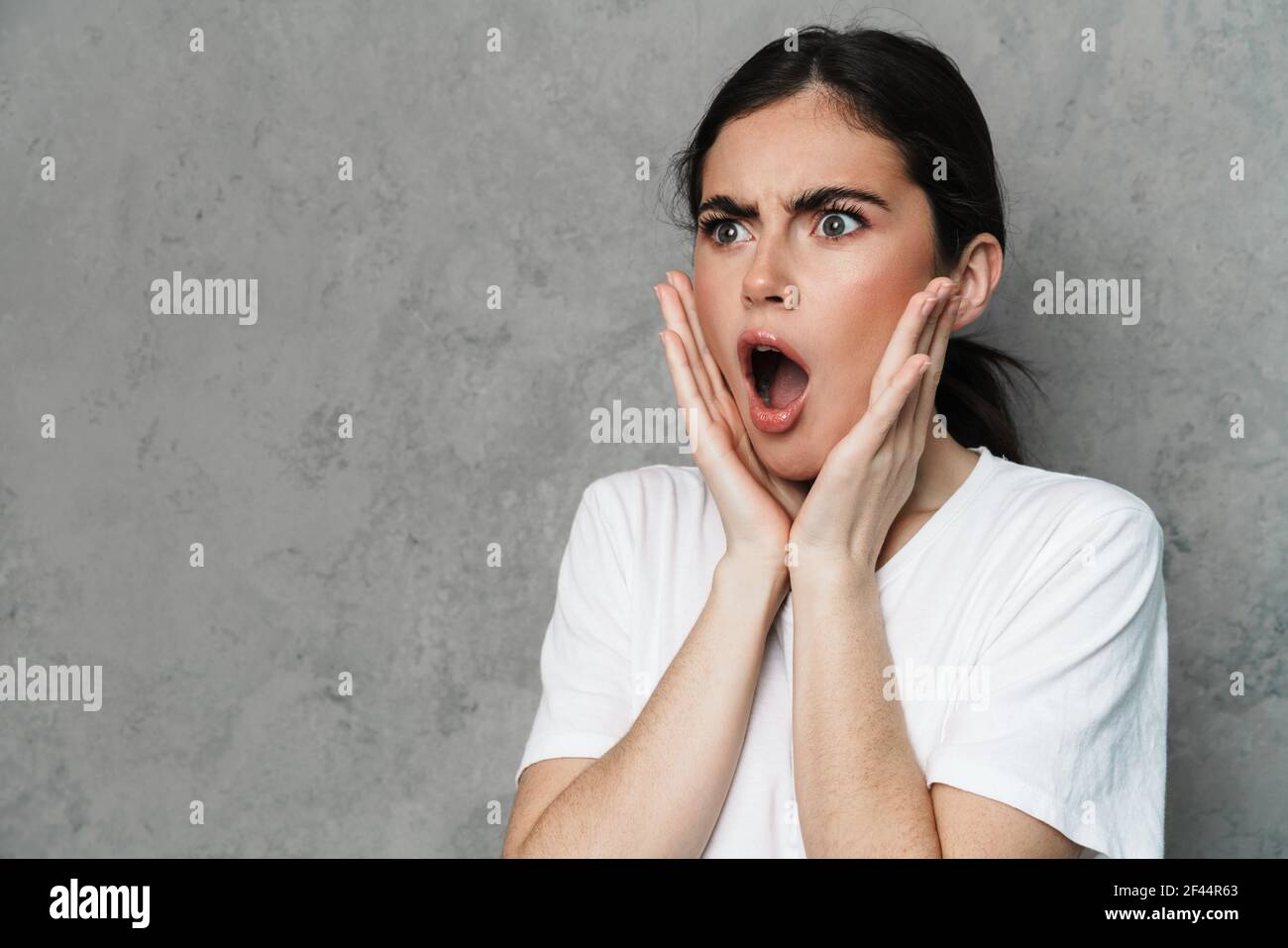 Shocked beautiful young woman screaming over isolated background Stock ...