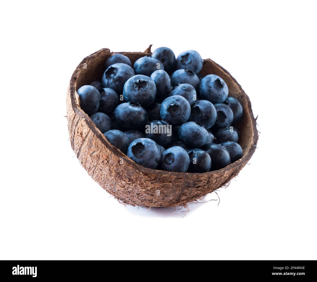Blueberries in coconut shell isolated on white background. Blueberries ...