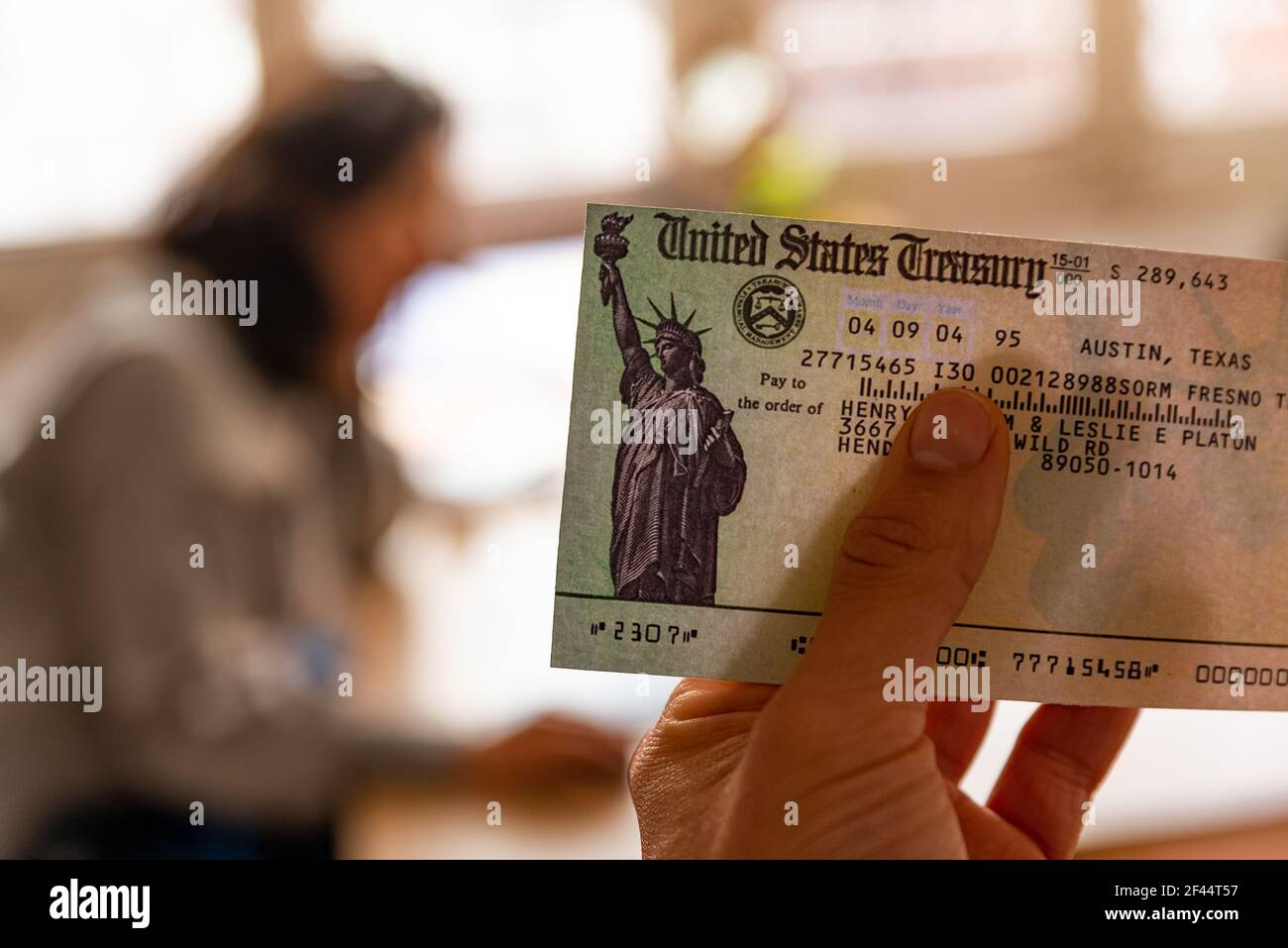 Washington, usa - 10 march 2021: hand holding stimulus check and face ...