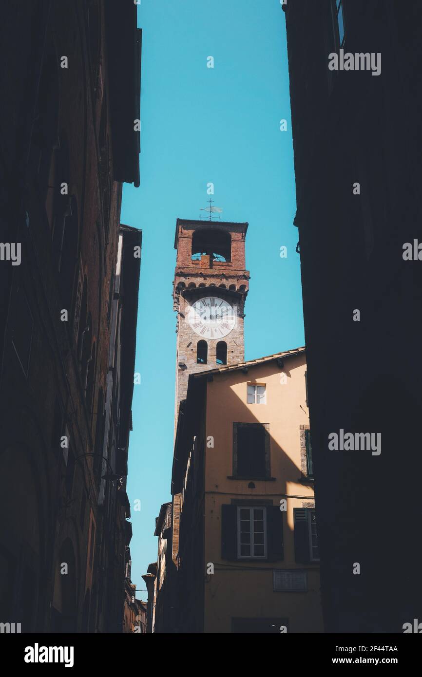 A vertical shot of an old clock tower in Lucca under the sunlight Stock ...
