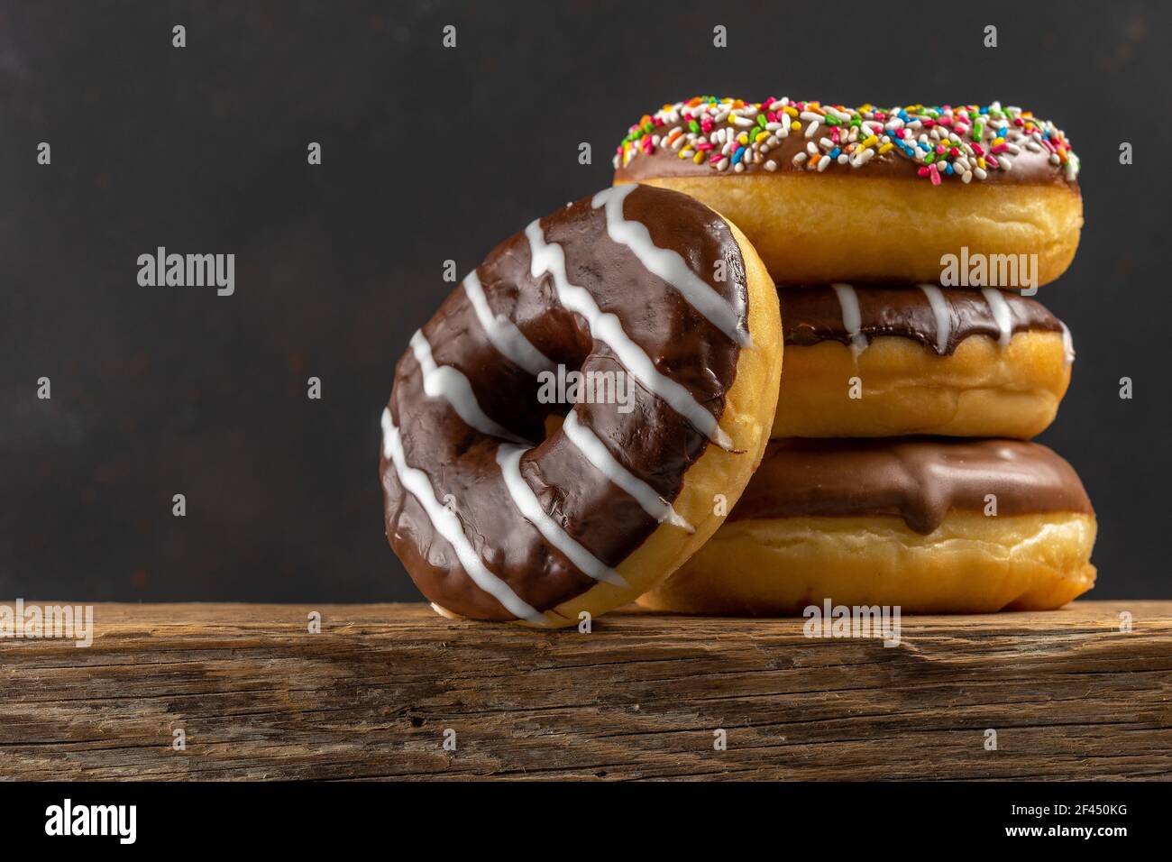 Delicious donuts on rustic wooden table. Food concept Stock Photo - Alamy