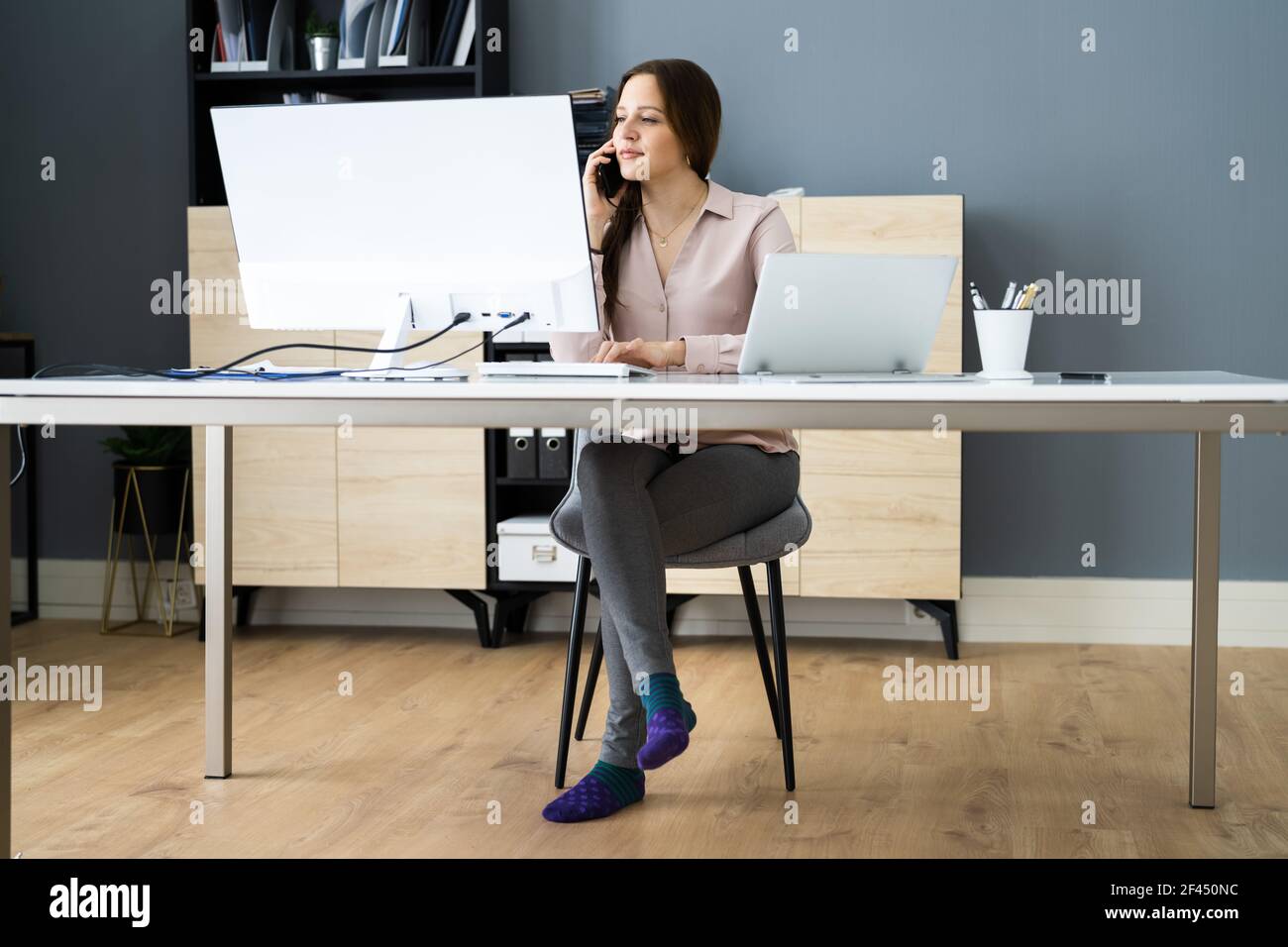 Computer Desk At Work In Office Funny Socks Stock Photo - Alamy