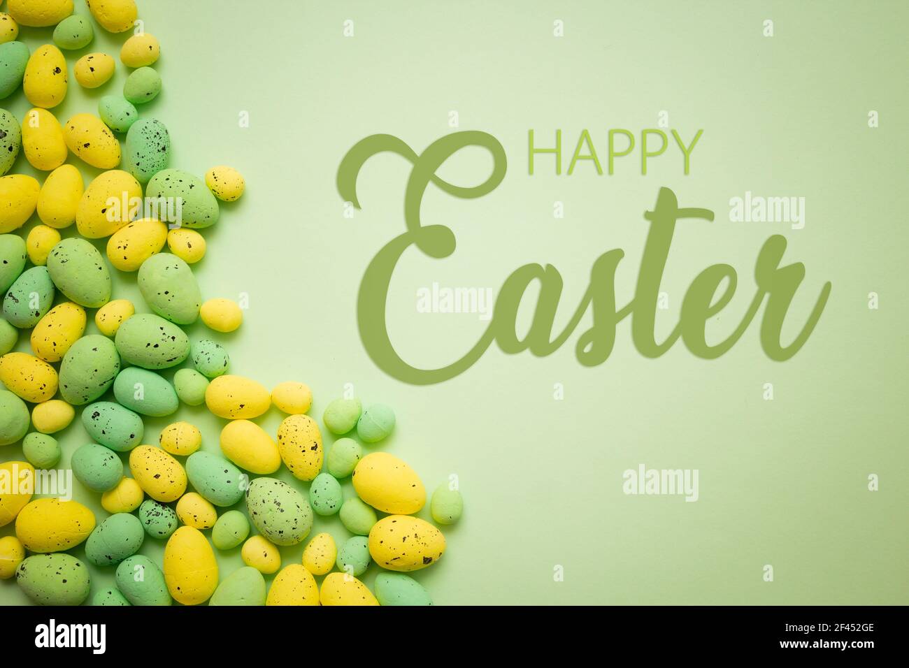 Yellow and green Easter eggs on green background with happy easter ...