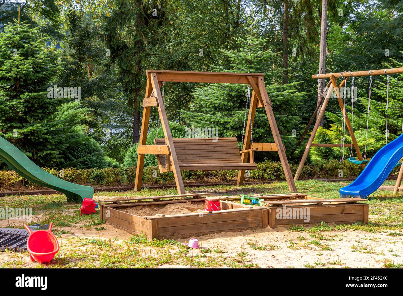 Empty modern wooden children playground set on green yard in public ...