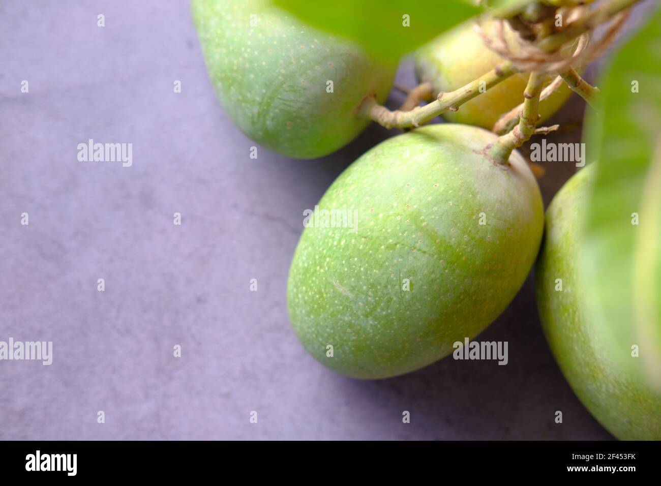 Fresh green mango on black background top down Stock Photo - Alamy