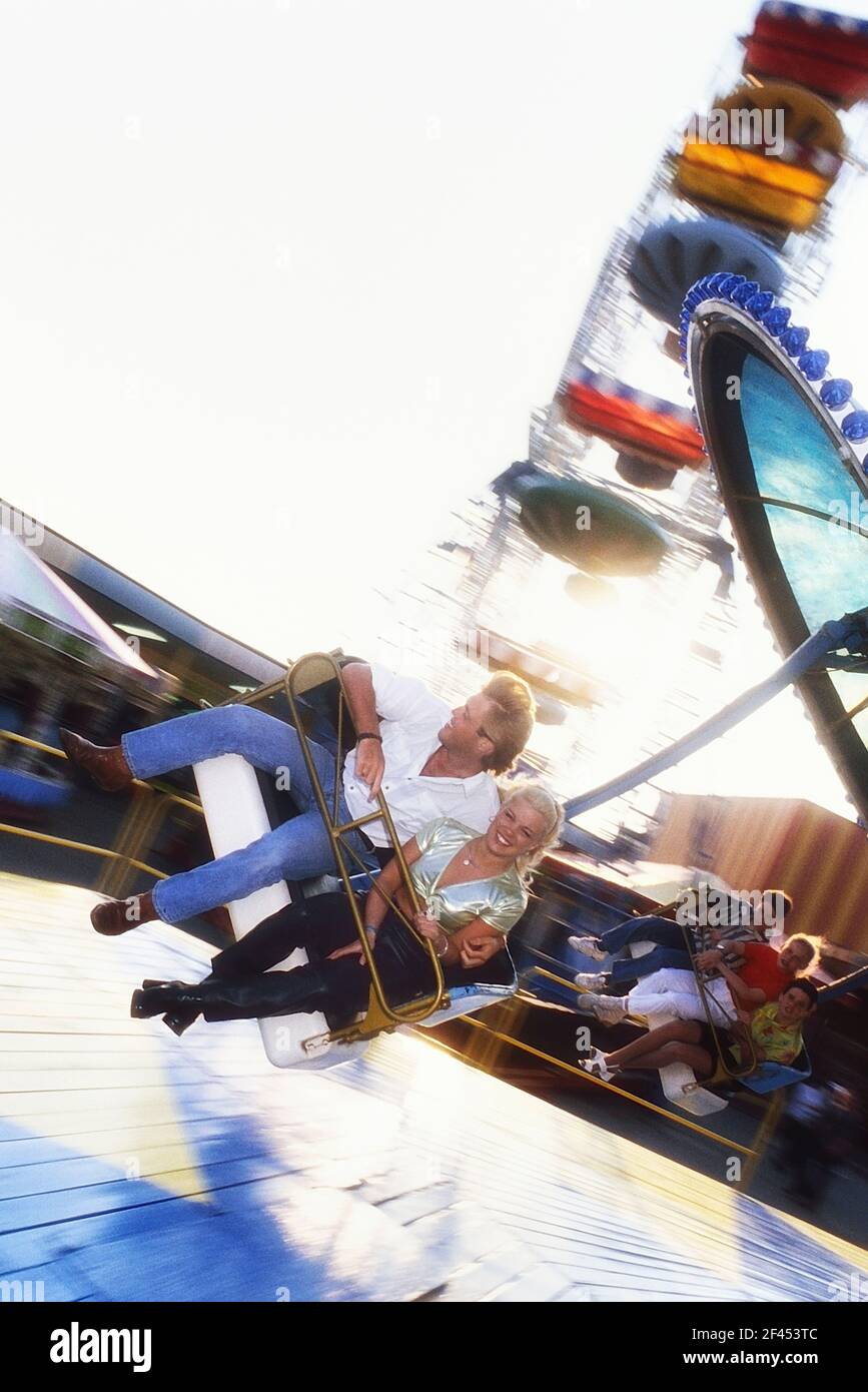 Young adult couple on the Umbrella/ Lifting Paratroopers ride at ...