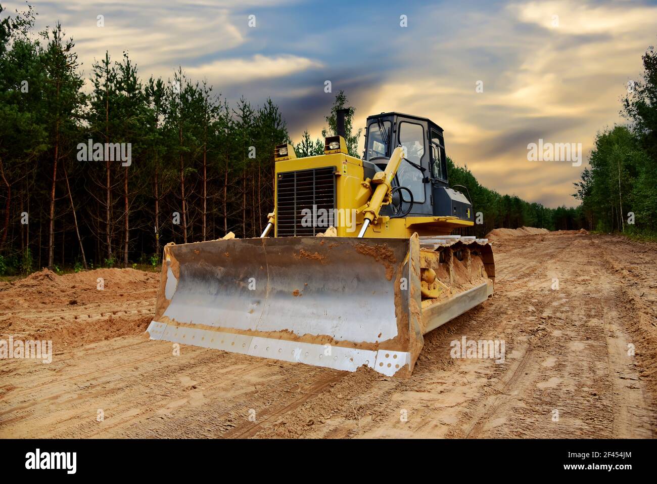 Dozer during clearing forest for construction new road. Bulldozer at ...