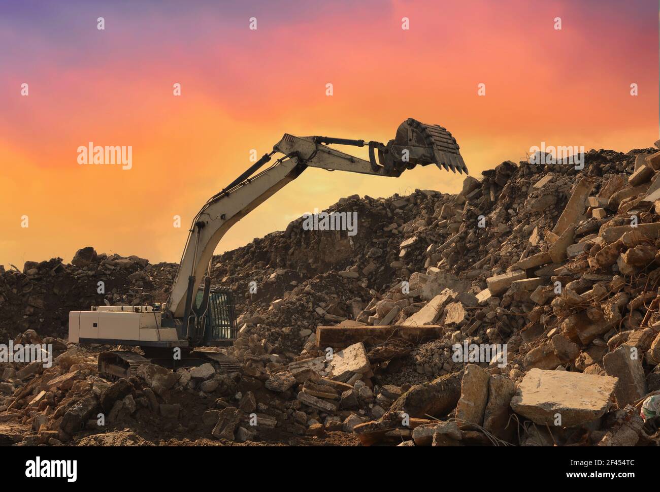 Recycling concrete and construction waste from demolition. Excavator at ...